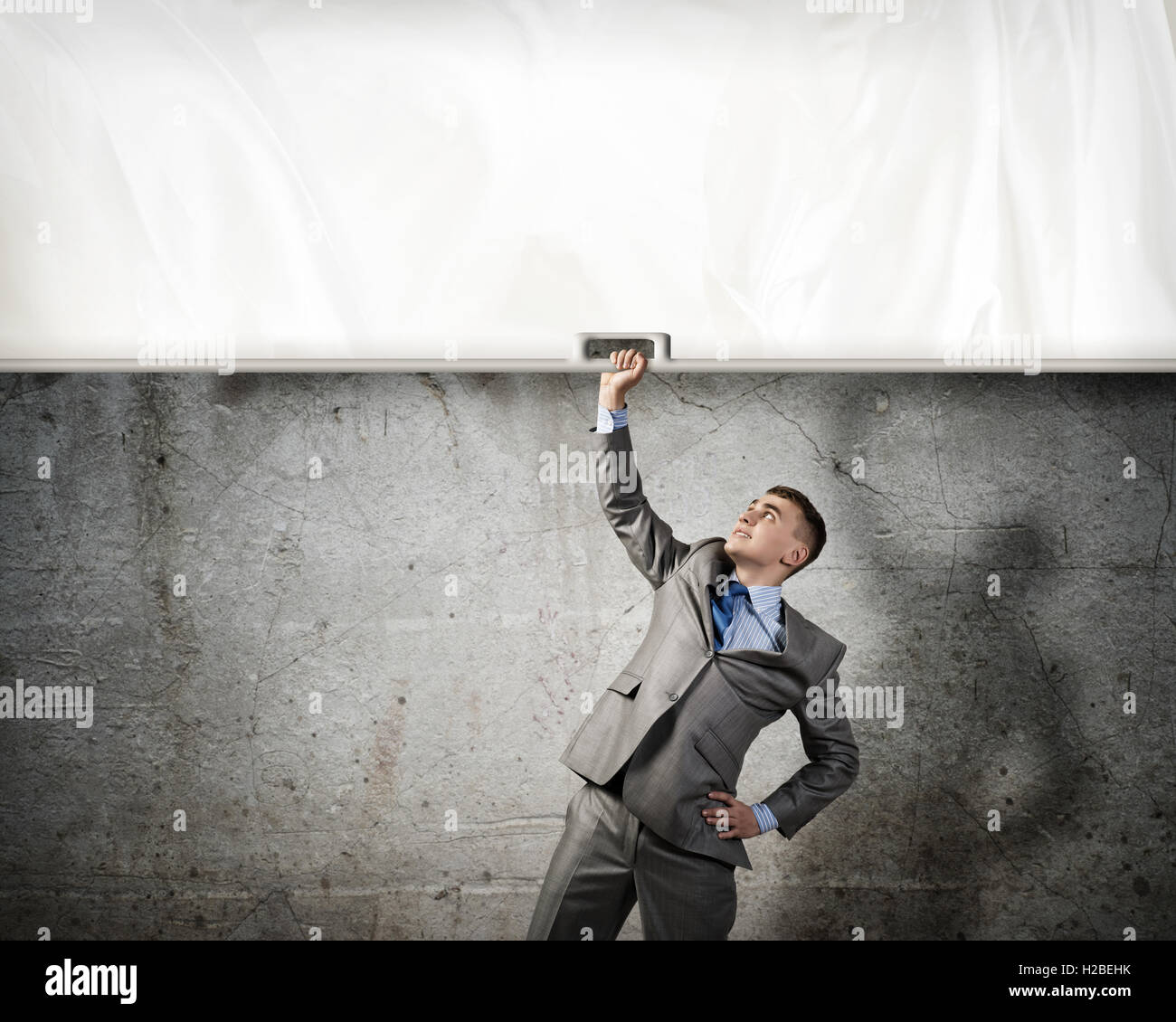 businessman holding a banner with one hand Stock Photo - Alamy
