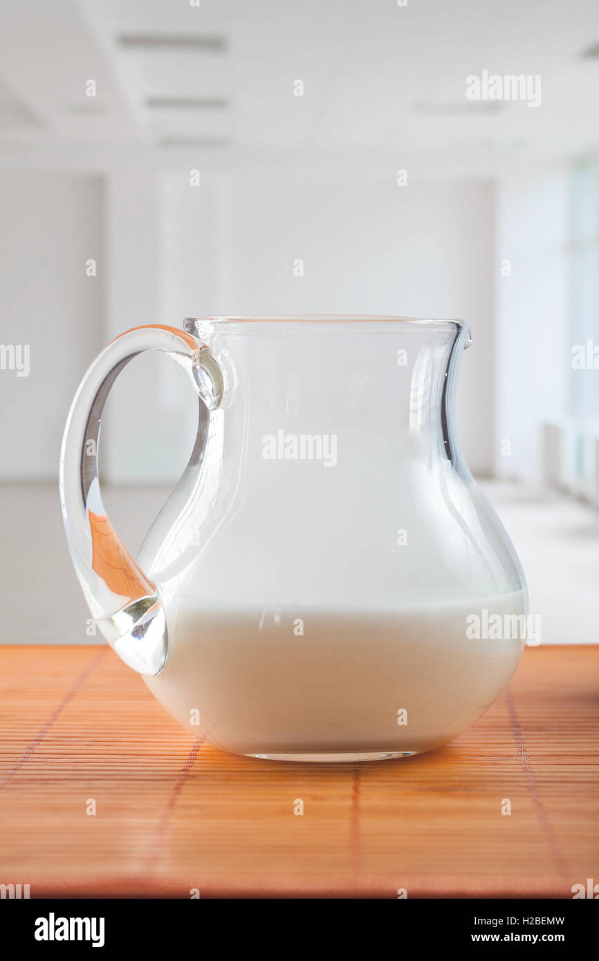 pitcher with milk on table Stock Photo - Alamy