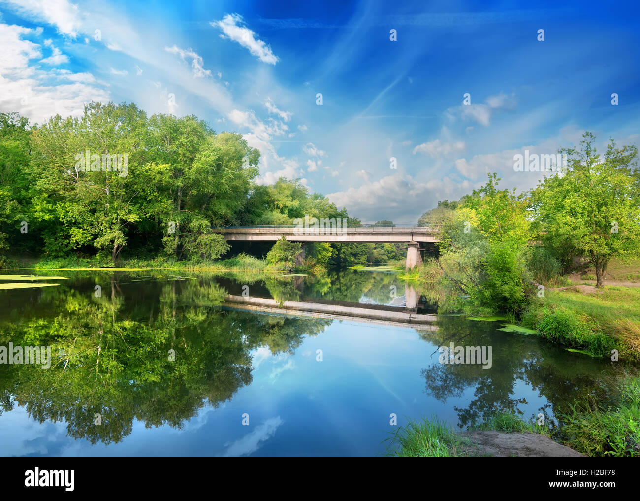 Bridge over silent river Stock Photo - Alamy