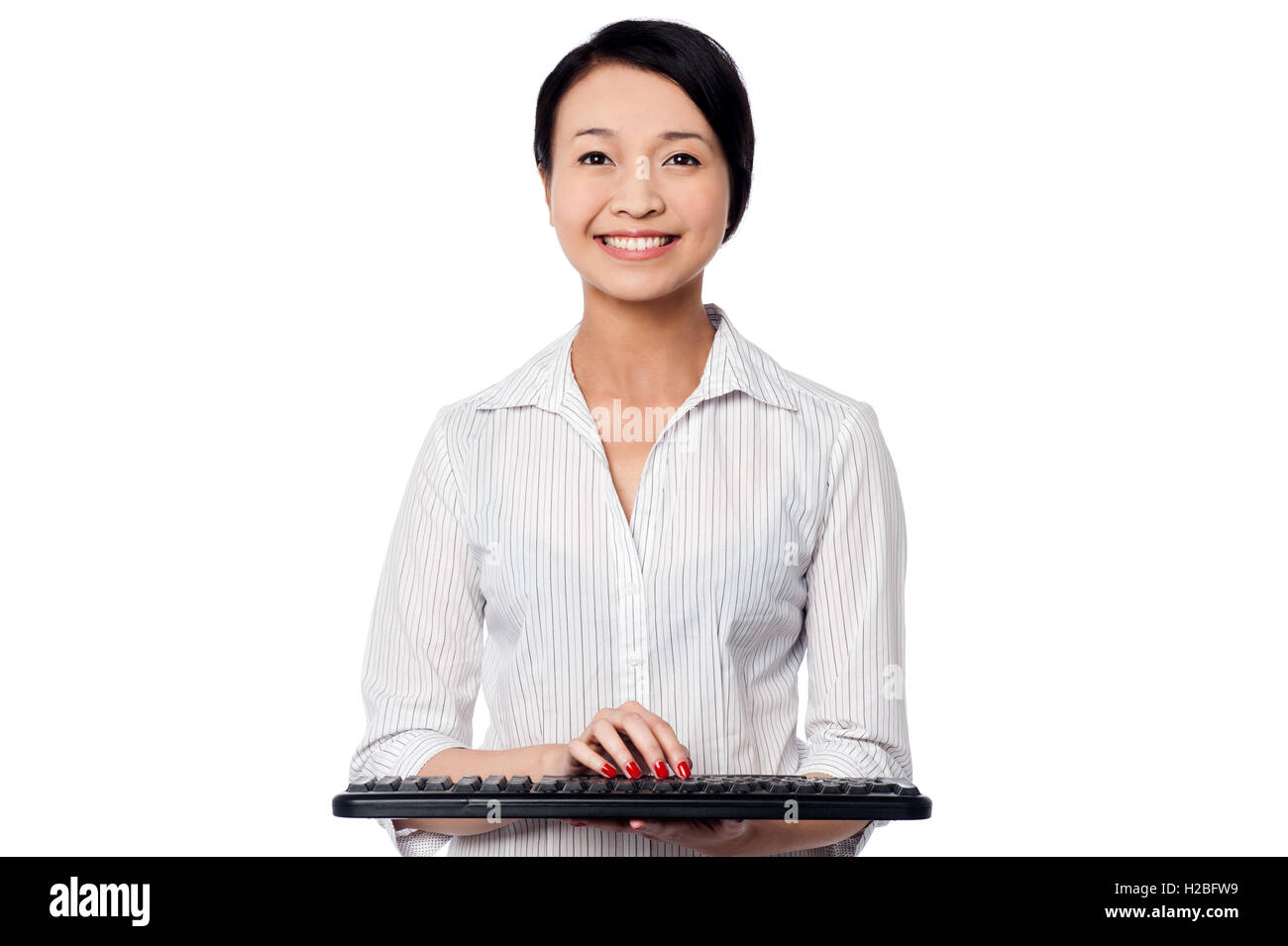 Smiling woman posing with keyboard Stock Photo - Alamy
