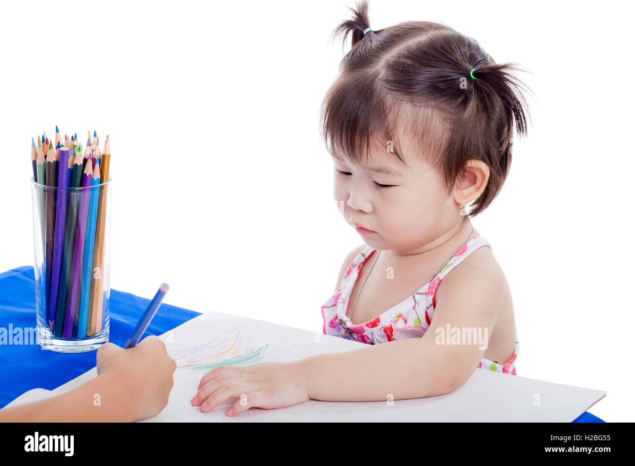 Little girl looking another child drawing a picture by color pencil ,on ...