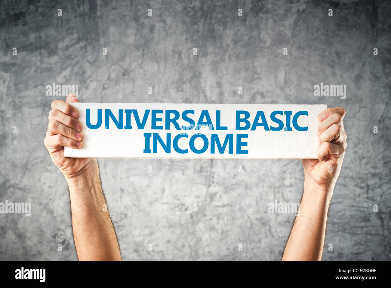 Universal basic income concept with hands holding banner Stock Photo ...
