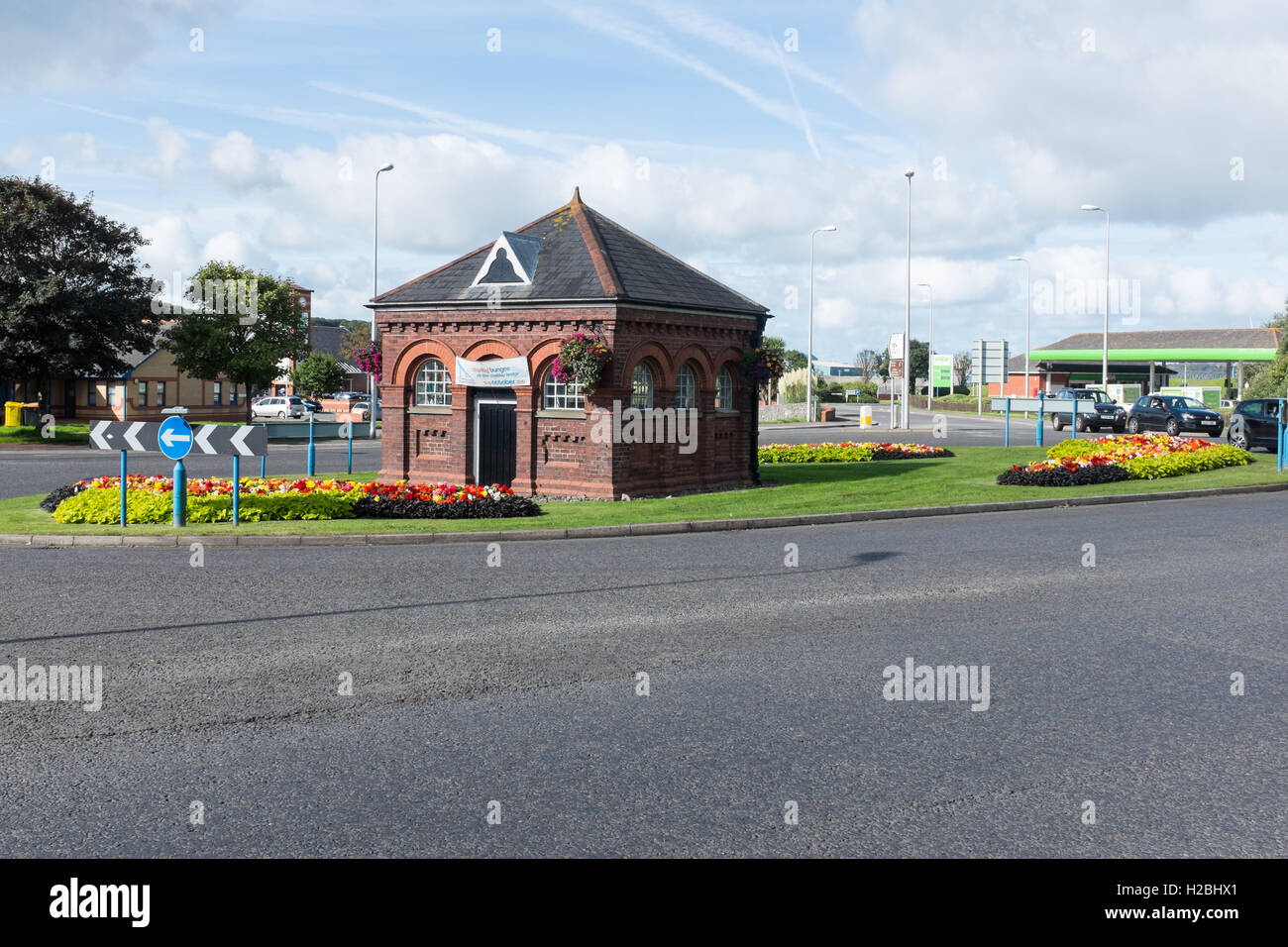 Old red brick building in the middle of a roundabout in Pembroke Docks ...