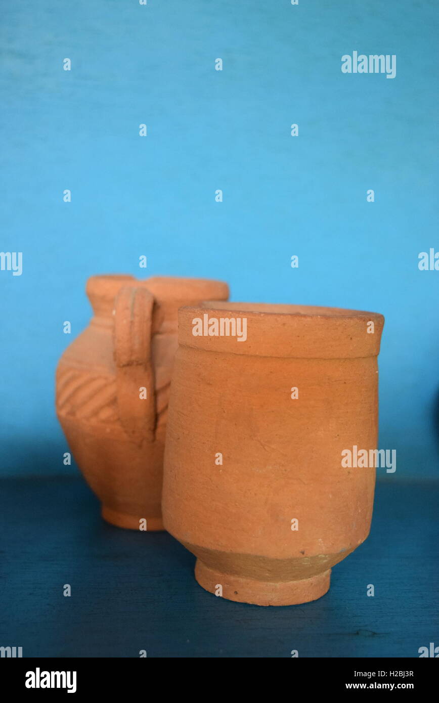 two ceramic vessels on a blue background Stock Photo - Alamy