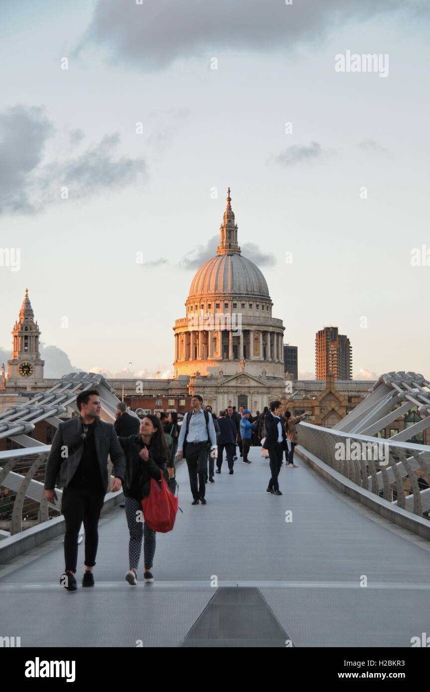 People crossing The Millennium Bridge, with St Paul's cathedral in the ...