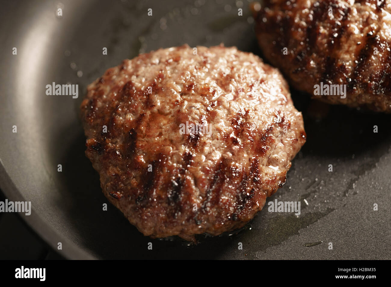 beef cutlets rest on frying pan Stock Photo - Alamy