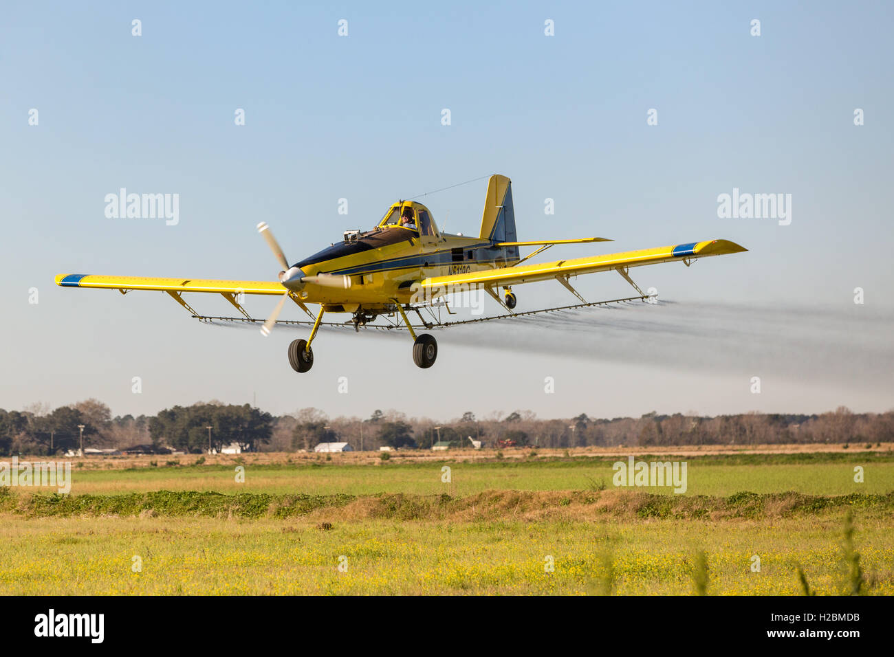 An aerial crop duster sprays a field in rural Eunice, Louisiana Stock ...
