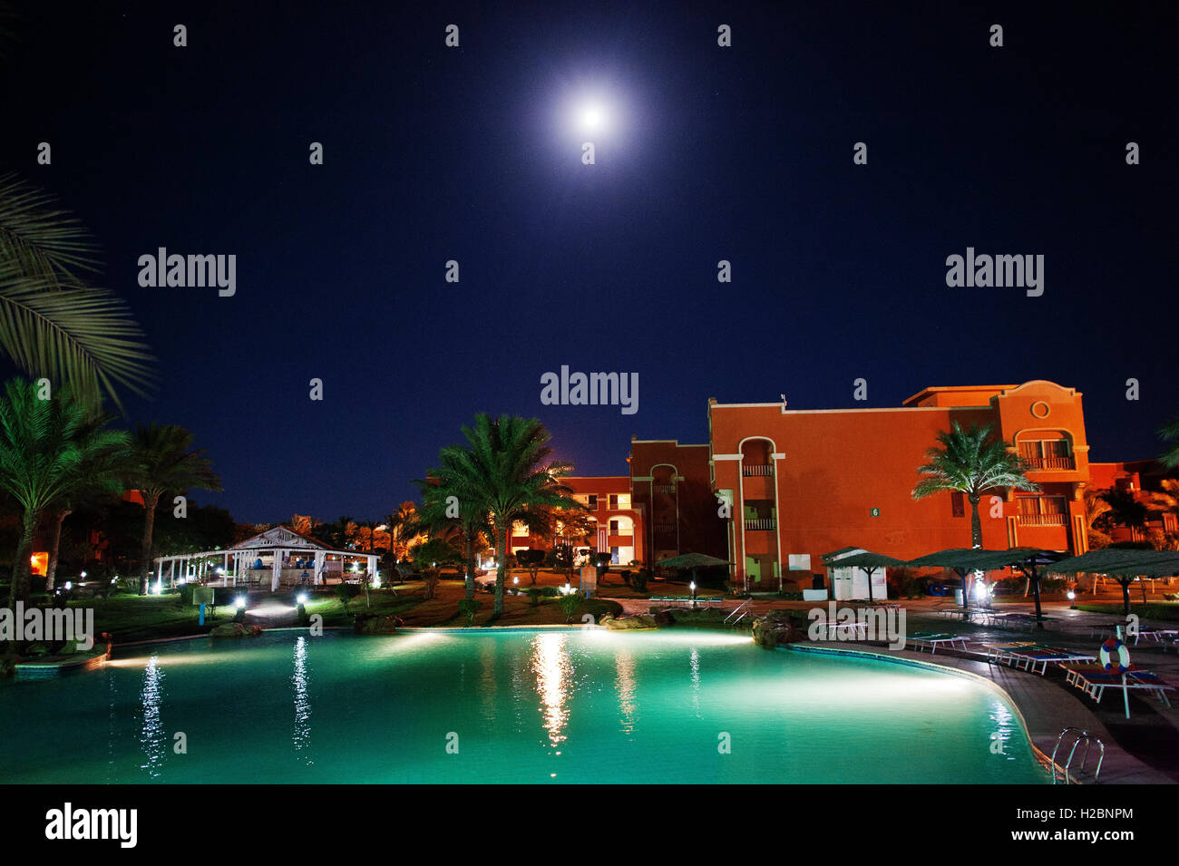 Swimming pool of a luxury tropical caribbean resort at night with moon ...