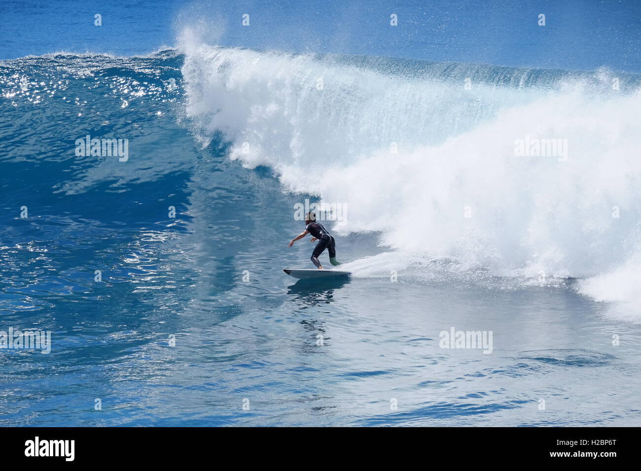 Young man surfing in the waves of the Atlantic Ocean near Jardim do Mar ...