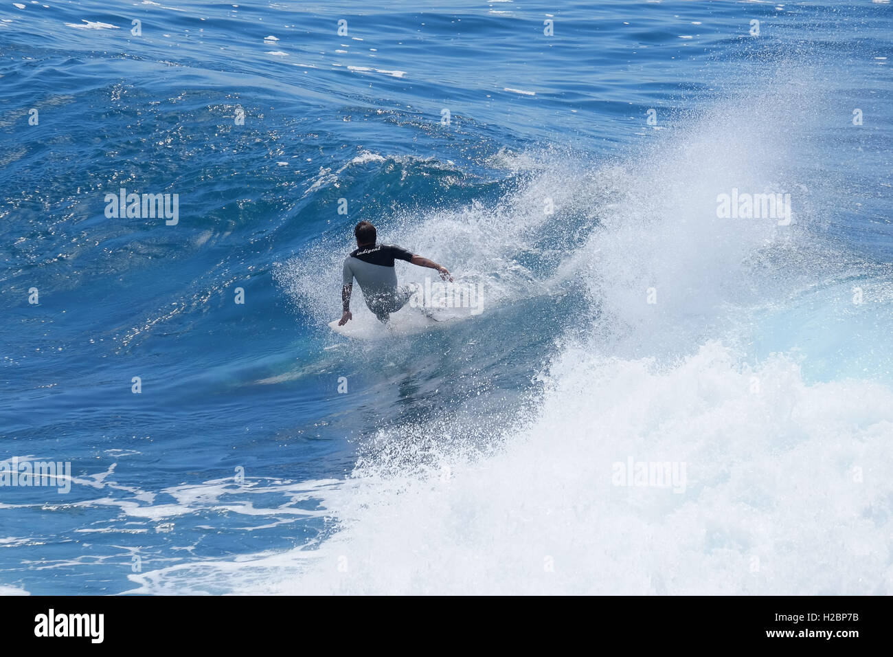 Young man surfing in the waves of the Atlantic Ocean near Jardim do Mar ...