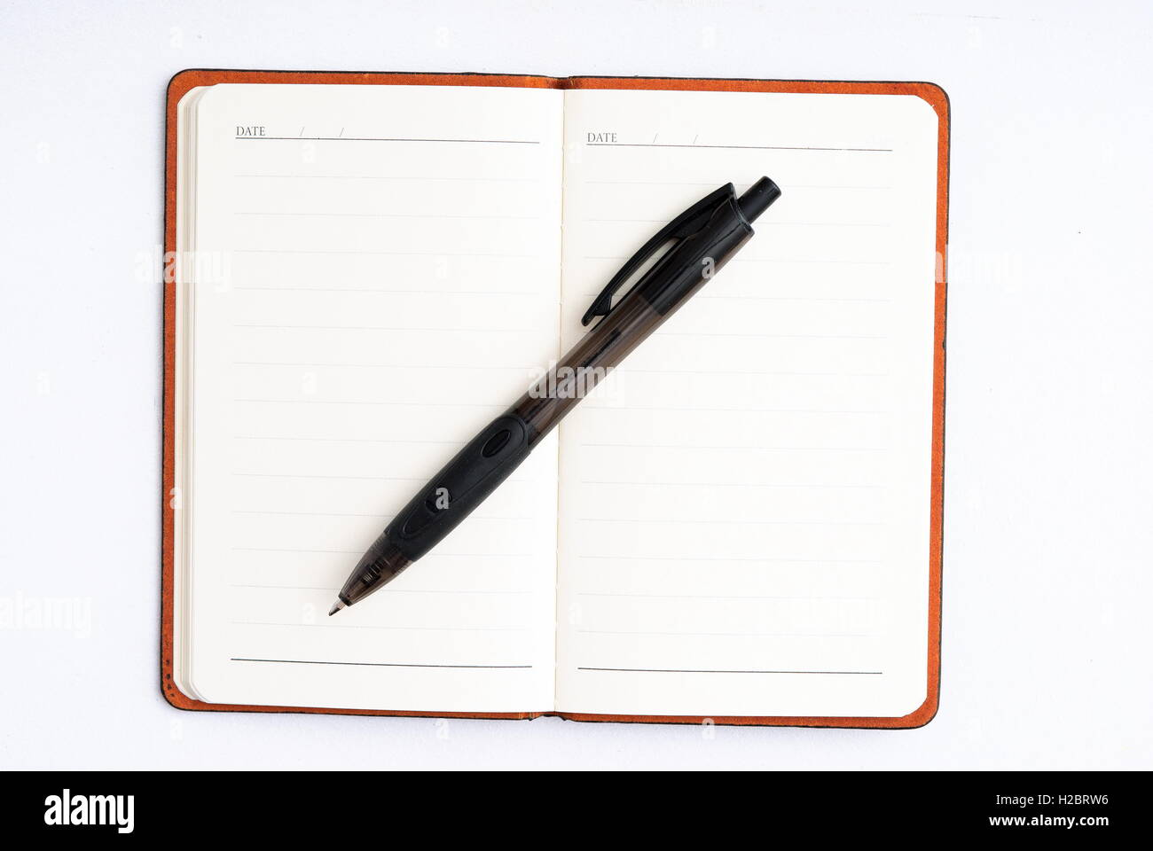 notepad with pen isolated Stock Photo - Alamy