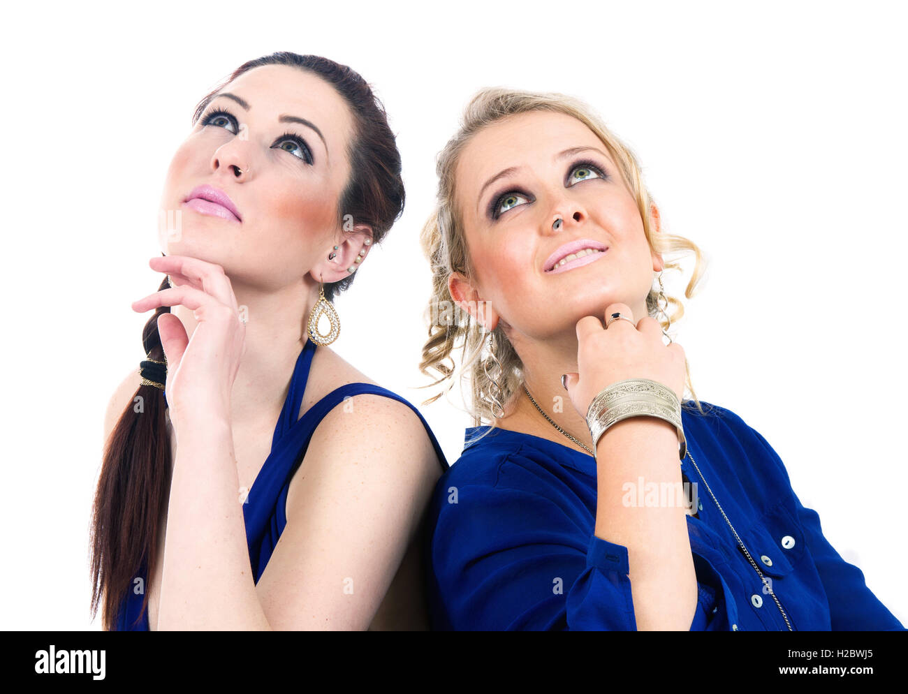 two beautiful thinking girls on white Stock Photo - Alamy