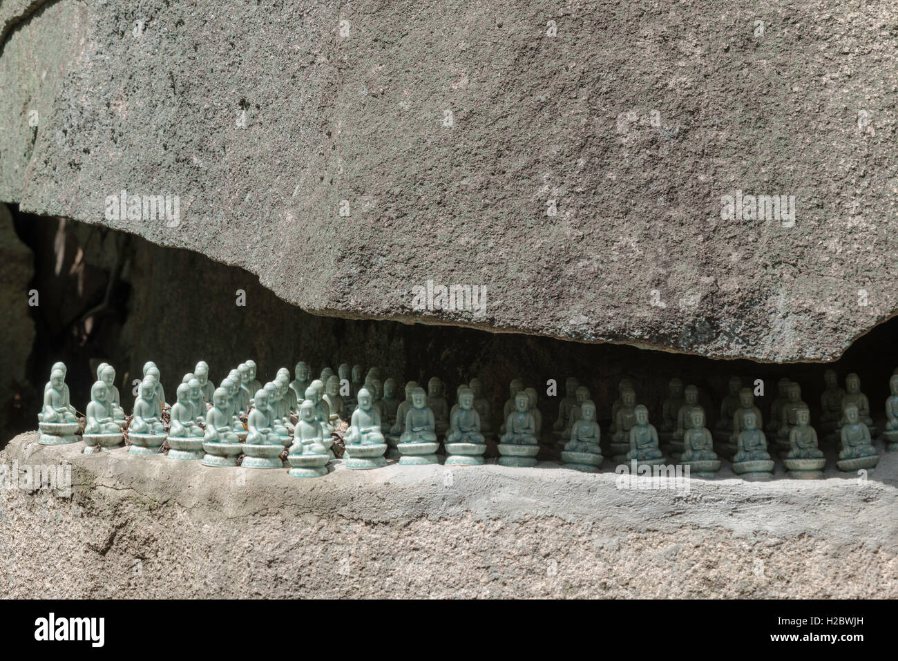 Buddhist monk ornaments / figurines hidden in rocks Stock Photo - Alamy