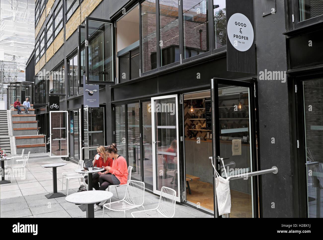 Young women with laptop computers drinking tea outside "Good & Proper ...