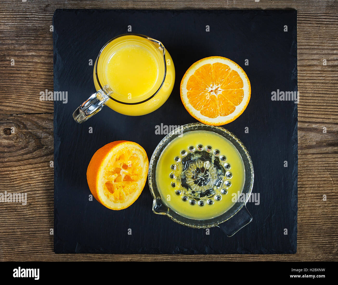 Freshly squeezed orange juice on slate board Stock Photo - Alamy