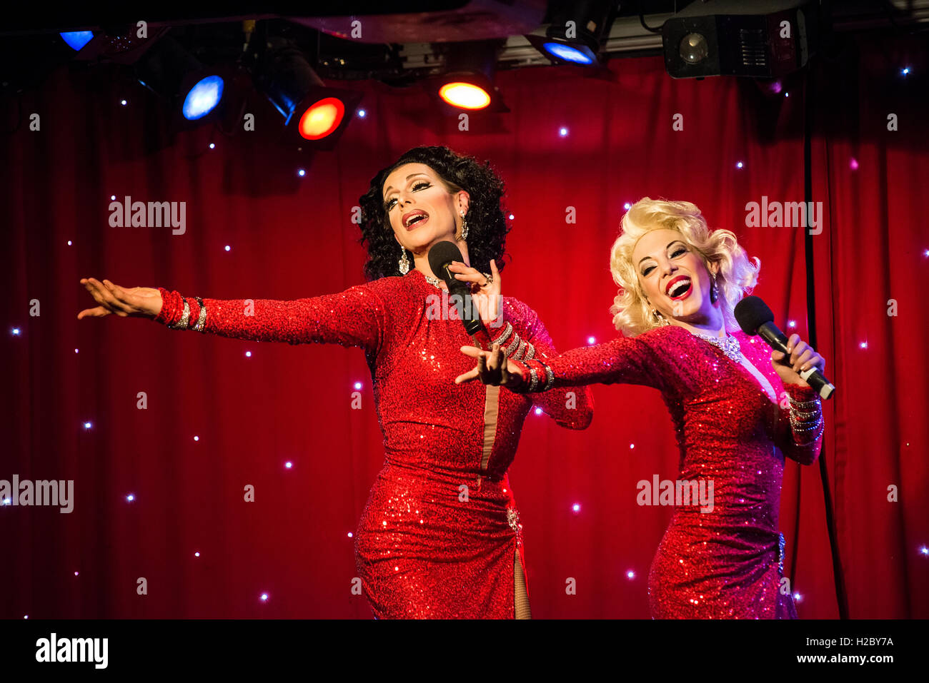 A drag queen (left) and an actress (right) sing while performing during ...