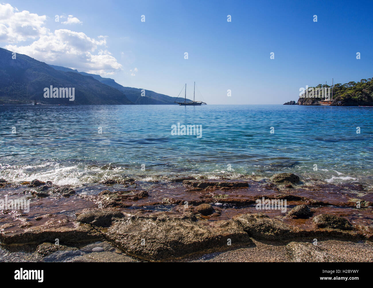 Seascape with sail ship and stones Stock Photo - Alamy