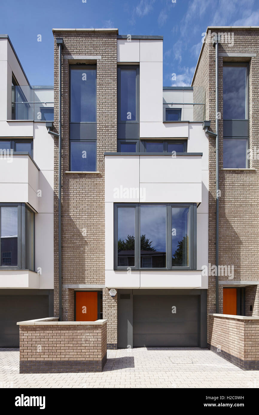 Front view of one townhouse with balcony and large windows. Peel Place ...