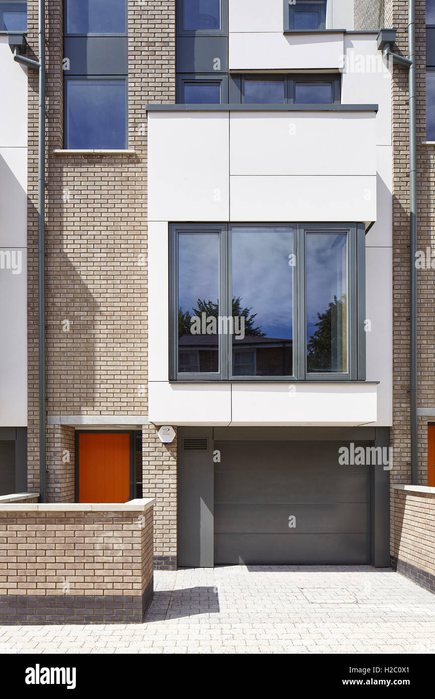 Close in front view of one townhouse with balcony and large windows ...