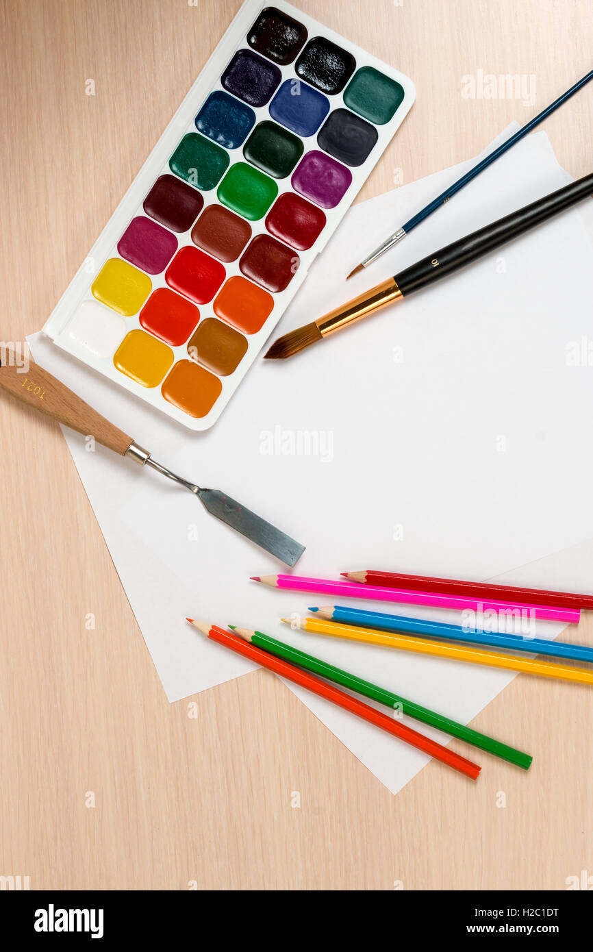 paints and pencils for drawing are around a blank slate Stock Photo - Alamy