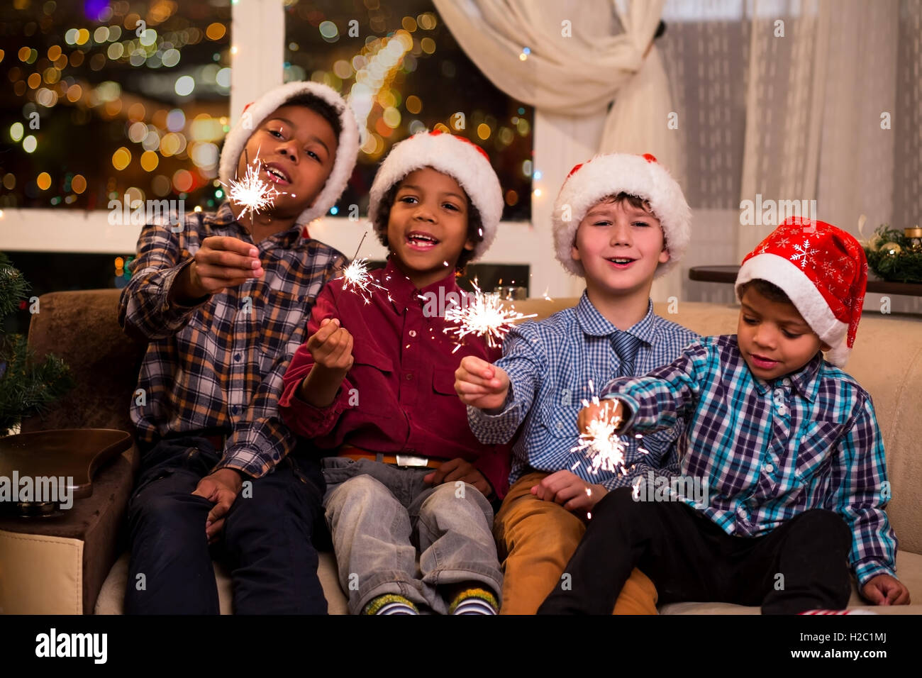 Happy children celebrating Christmas Stock Photo - Alamy