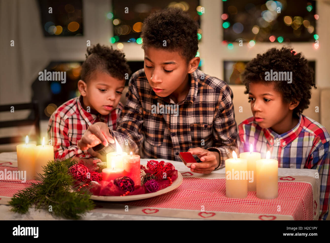 Boys light candles with matches Stock Photo - Alamy