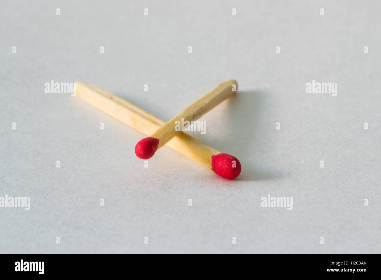 Two matches on white background Stock Photo - Alamy