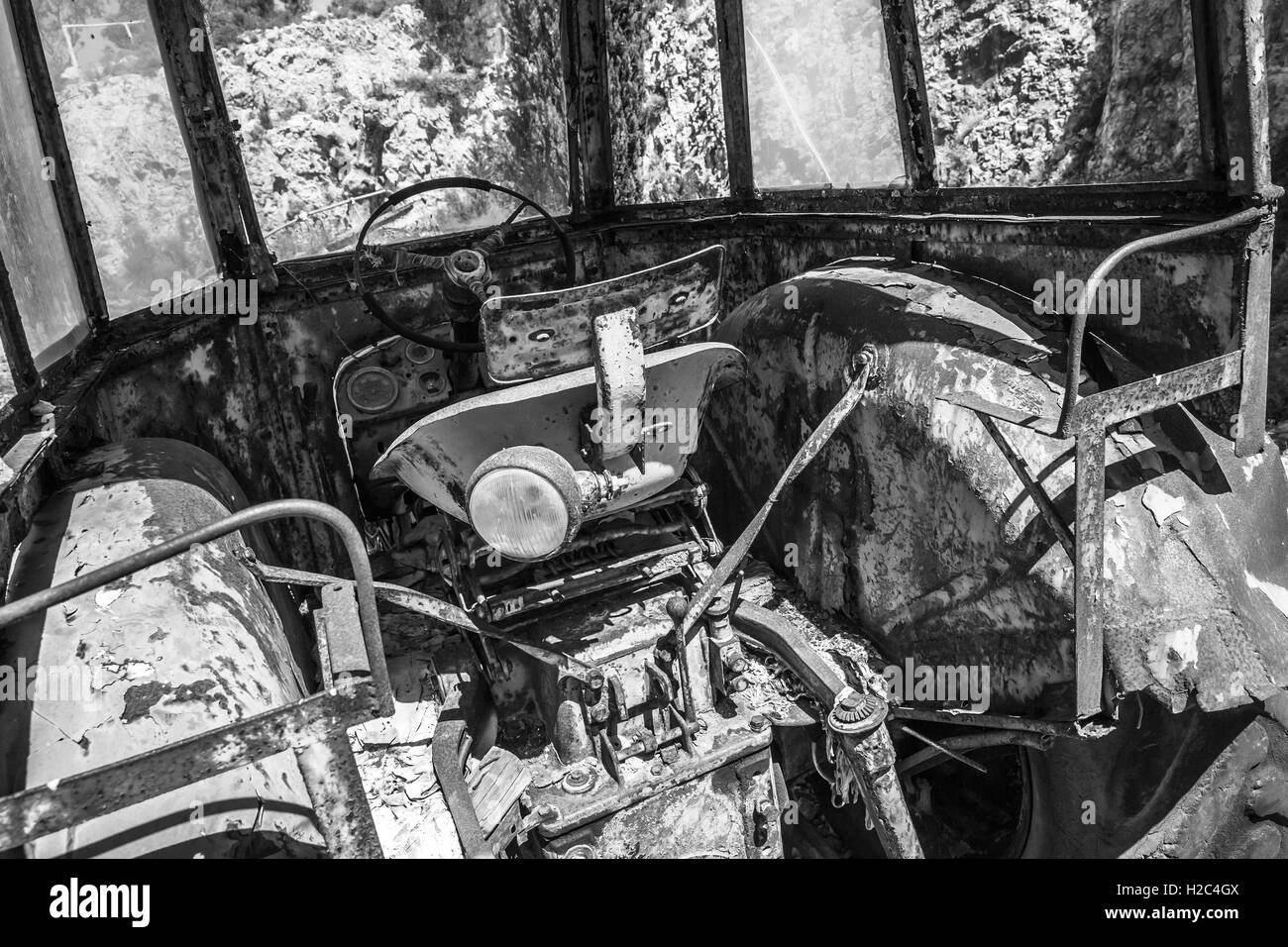 Old abandoned rusted tractor cabin interior, black and white retro ...