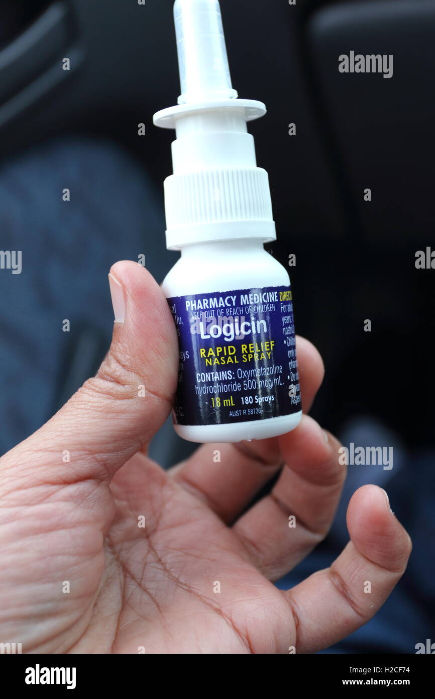 Close up image of hand holding Logicin nasal spray Stock Photo - Alamy
