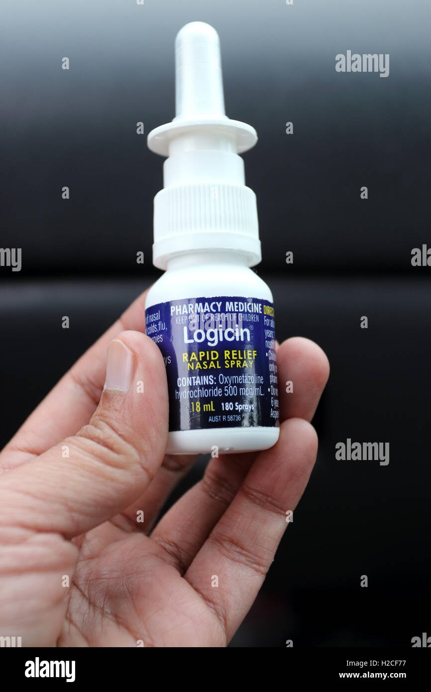Close up image of hand holding Logicin nasal spray Stock Photo - Alamy