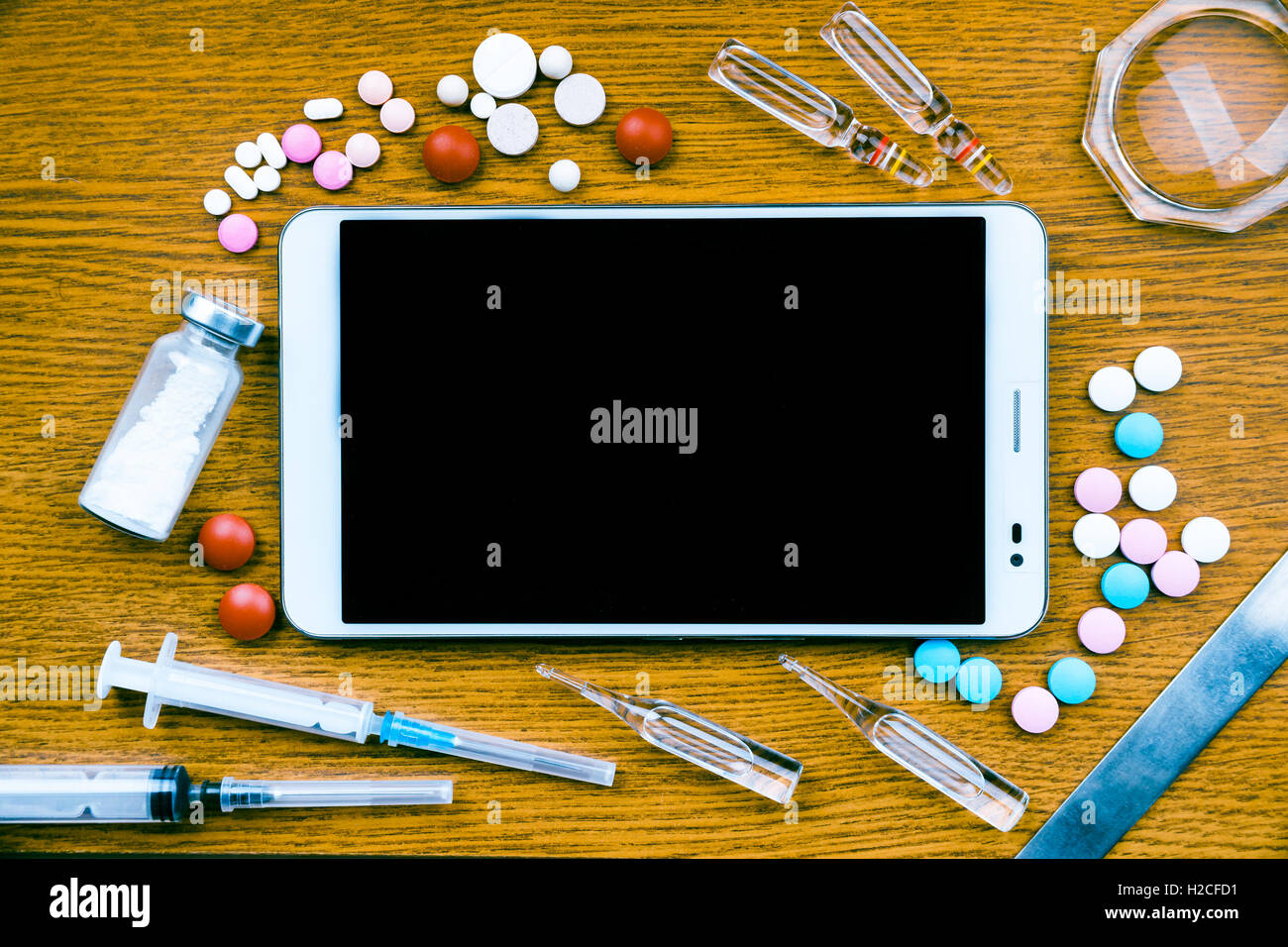 Tablet pc with medical objects on a desk Stock Photo - Alamy