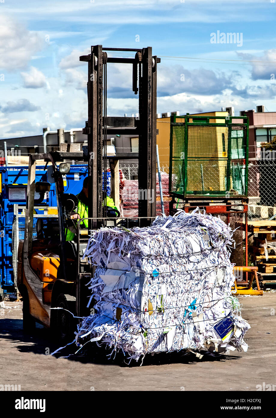 Forklift moving bales of waste paper ready for recycling Stock Photo ...