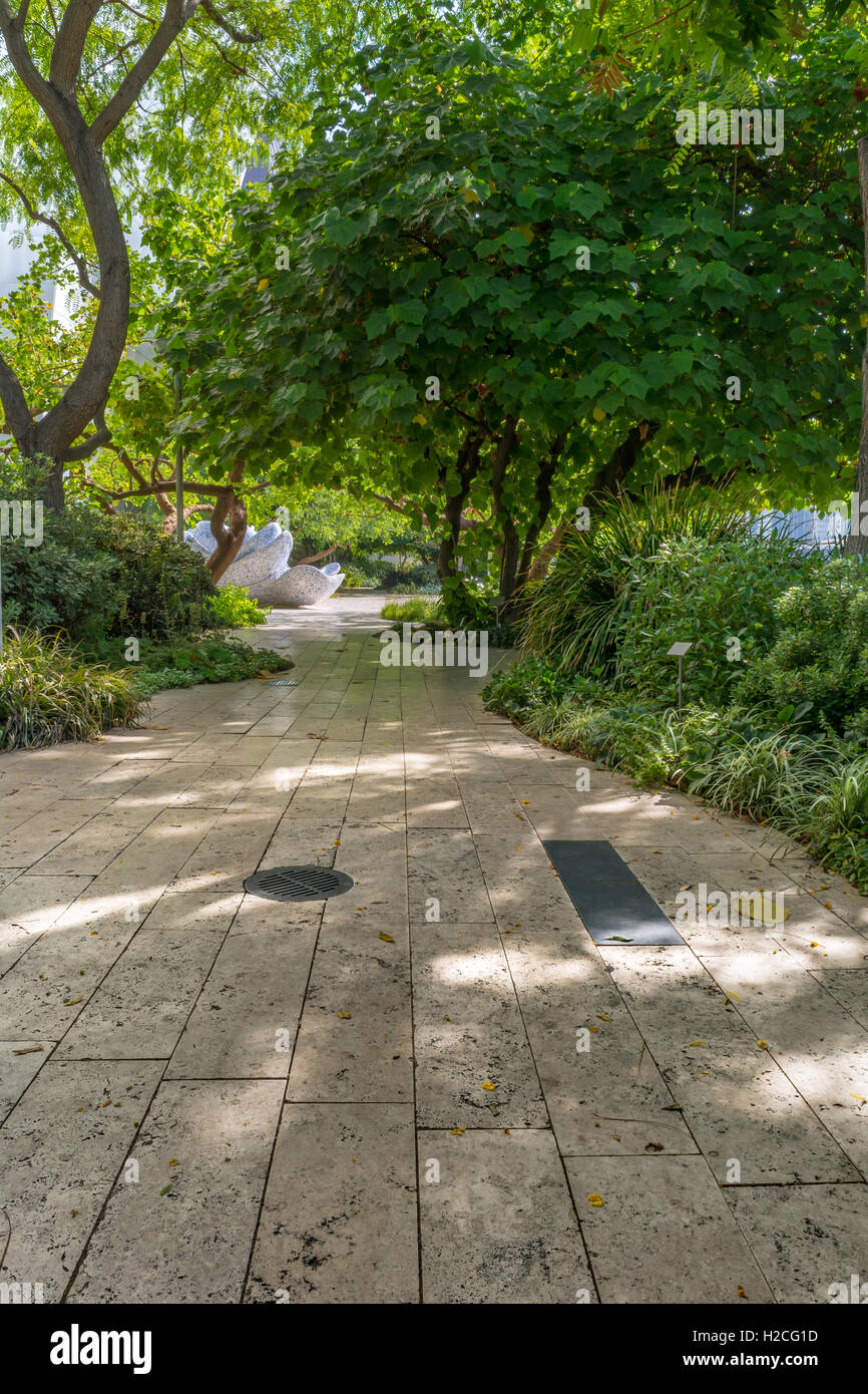 A shaded path along the back of the Walt Disney Concert Hall leading to ...