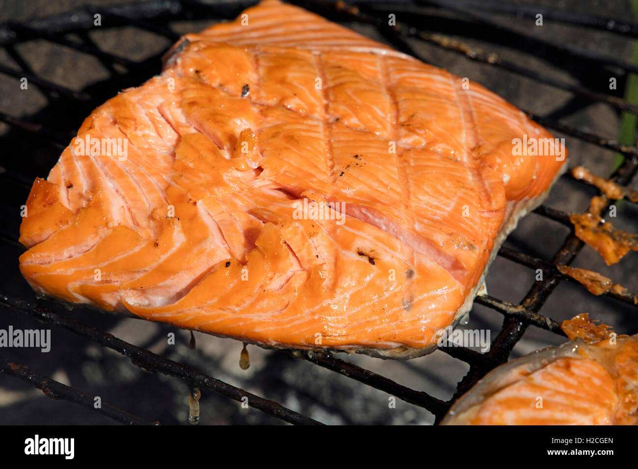 One grilled salmon fish fillet barbecue cooking prepared on bbq grill ...