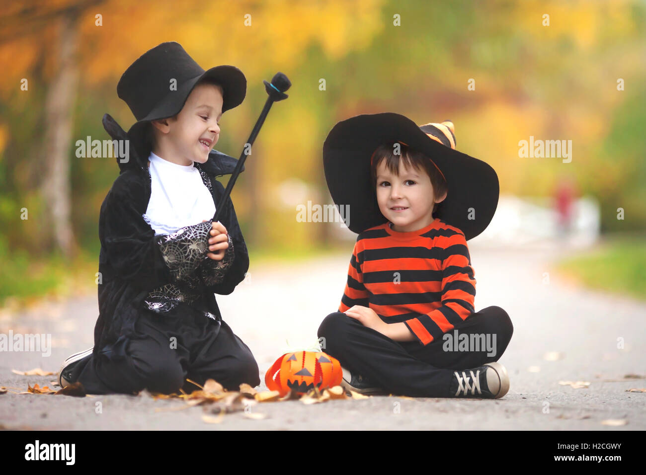Two boys in the park with Halloween costumes, having fun Stock Photo ...