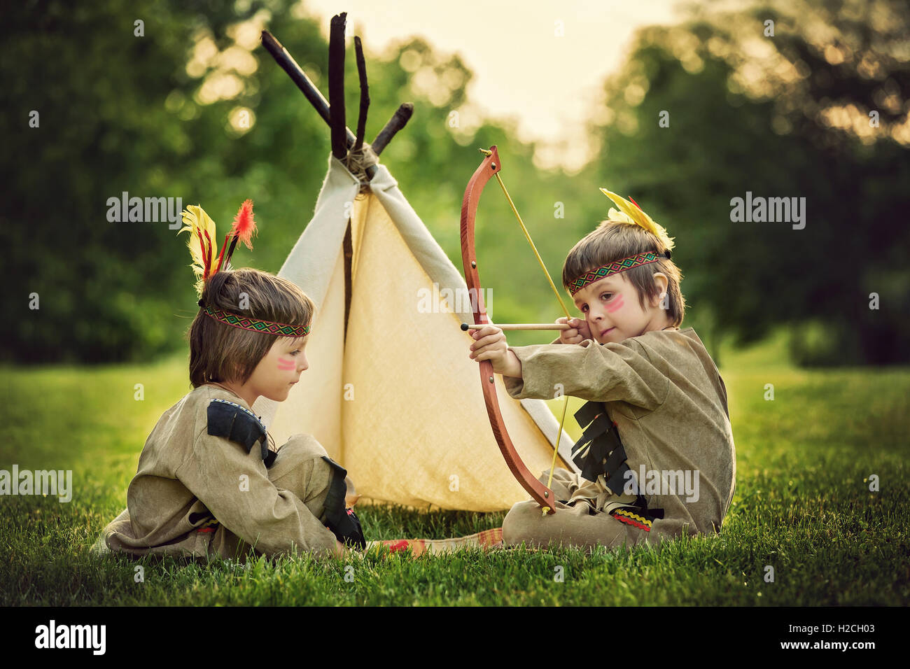 Cute portrait of native american boys with costumes, playing outdoor in ...