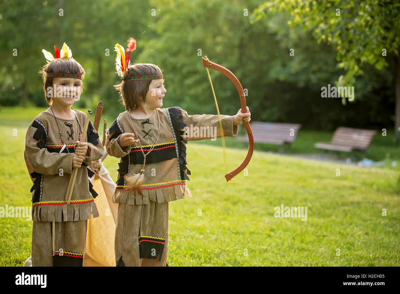 Cute portrait of native american boys with costumes, playing outdoor in ...