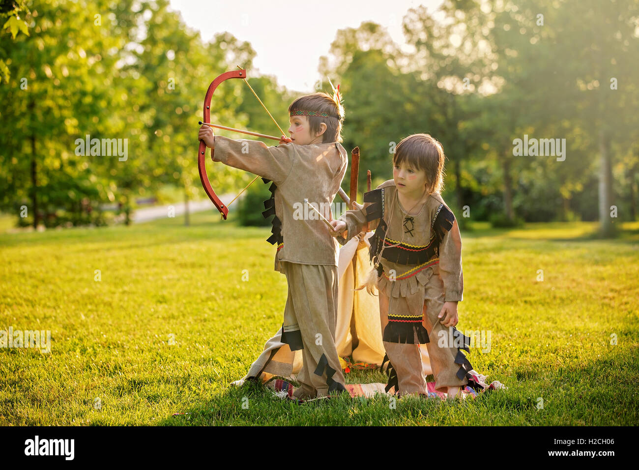 Cute portrait of native american boys with costumes, playing outdoor in ...