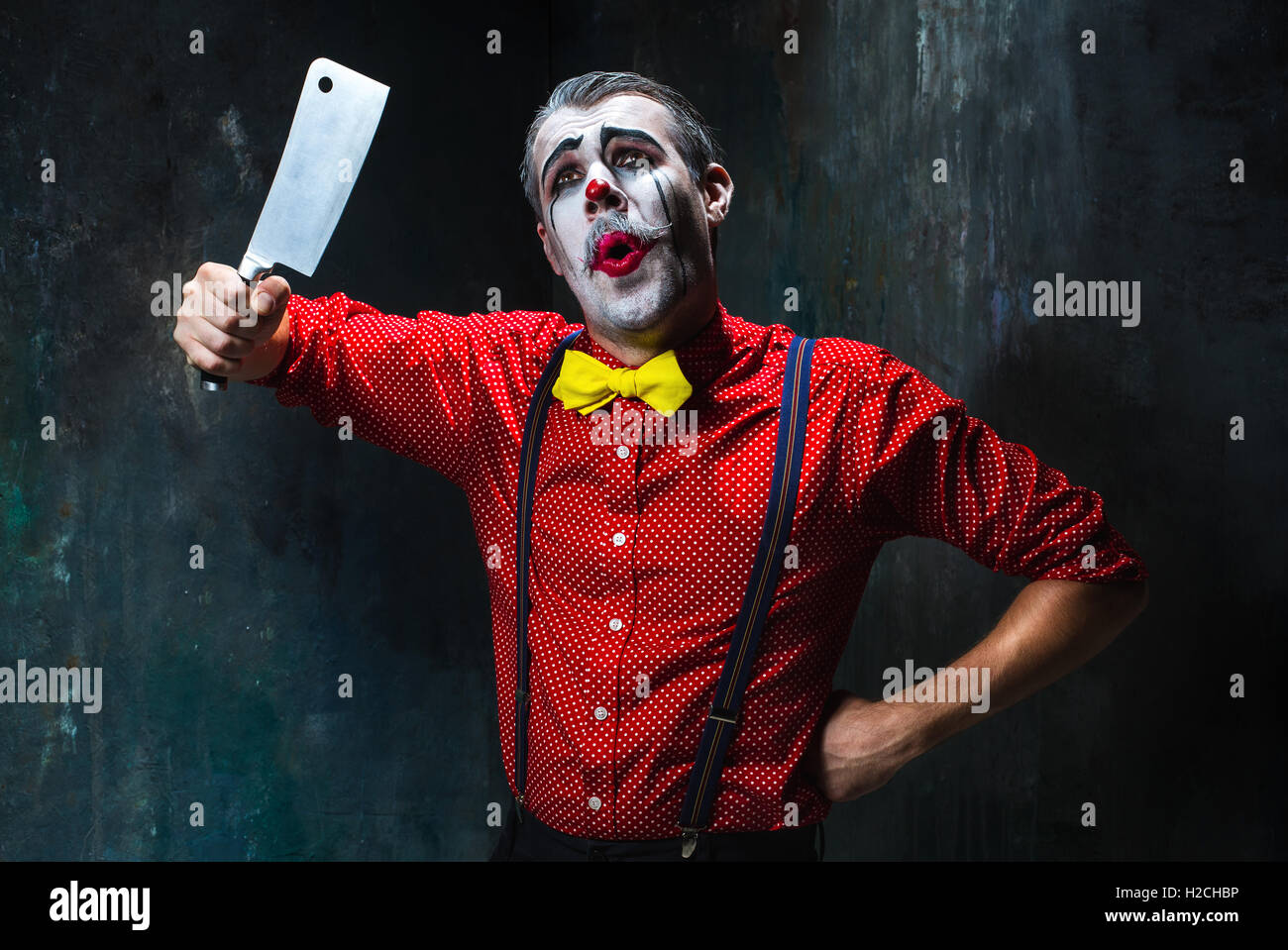 The scary clown holding a knife on dack. Halloween concept Stock Photo ...