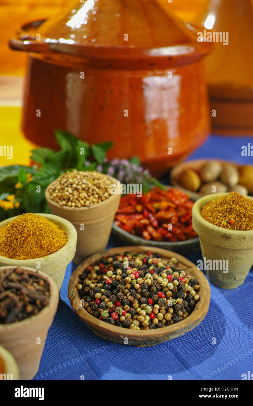 Collection of different spices in old clay bowls in colorful oriental ...