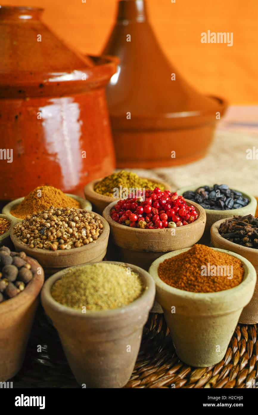 Collection of different spices in old clay bowls in colorful oriental ...