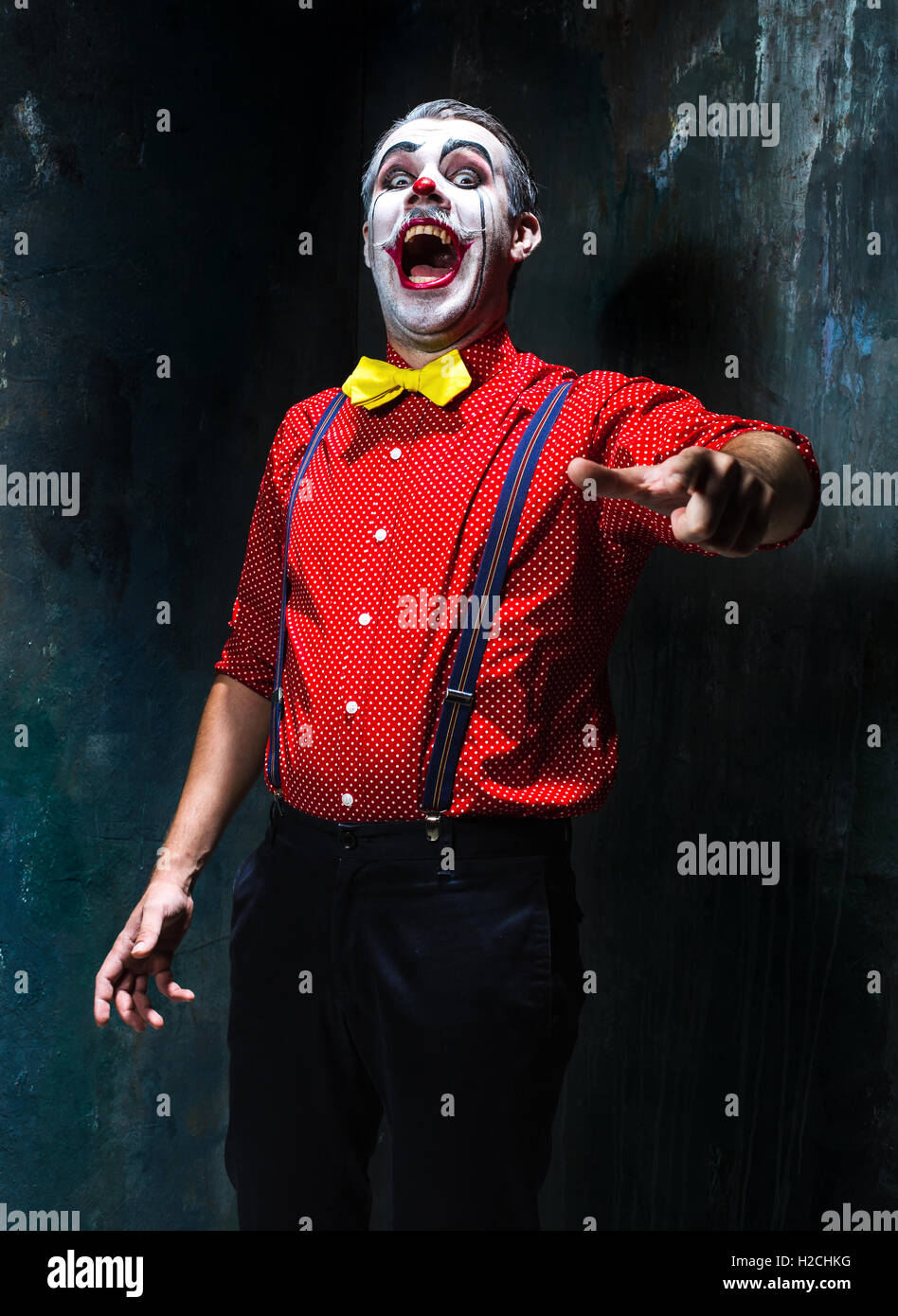 Terrible clown and Halloween theme: Crazy red clown in a shirt with ...