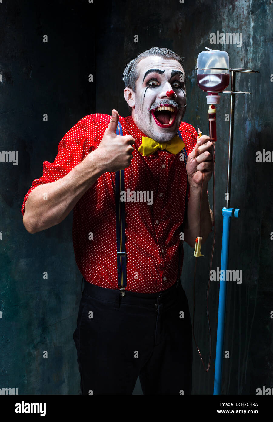 The scary clown and drip with blood on dack background. Halloween ...