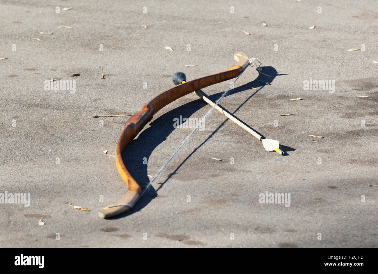 Medieval bow and arrow lying on a ground on sunny day Stock Photo - Alamy