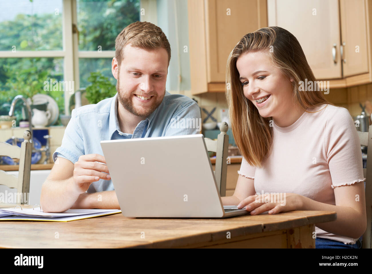 Male Home Tutor Helping Teenage Girl With Studies Stock Photo - Alamy