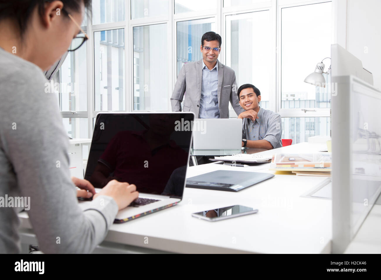 Businessmen with technology in office meeting Stock Photo - Alamy