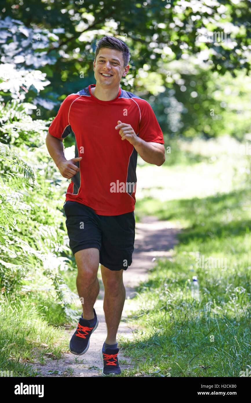 Young men running in park hi-res stock photography and images - Alamy