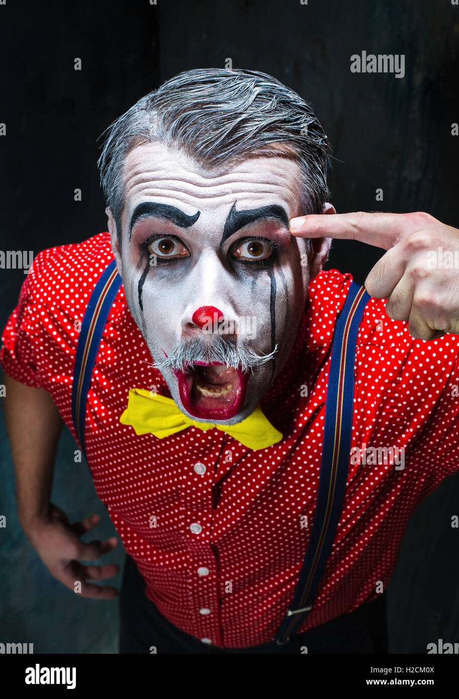 Terrible clown and Halloween theme: Crazy red clown in a shirt with ...