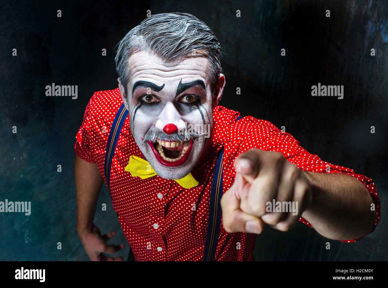 Terrible clown and Halloween theme: Crazy red clown in a shirt with ...