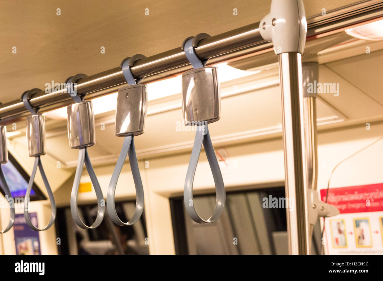 Handles for standing passenger inside a train Stock Photo - Alamy